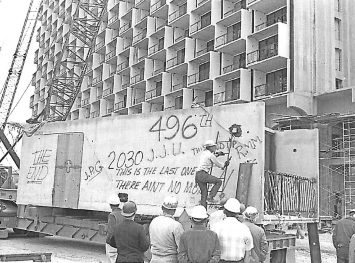 Then: Construction workers sign the last modular room before it was ...